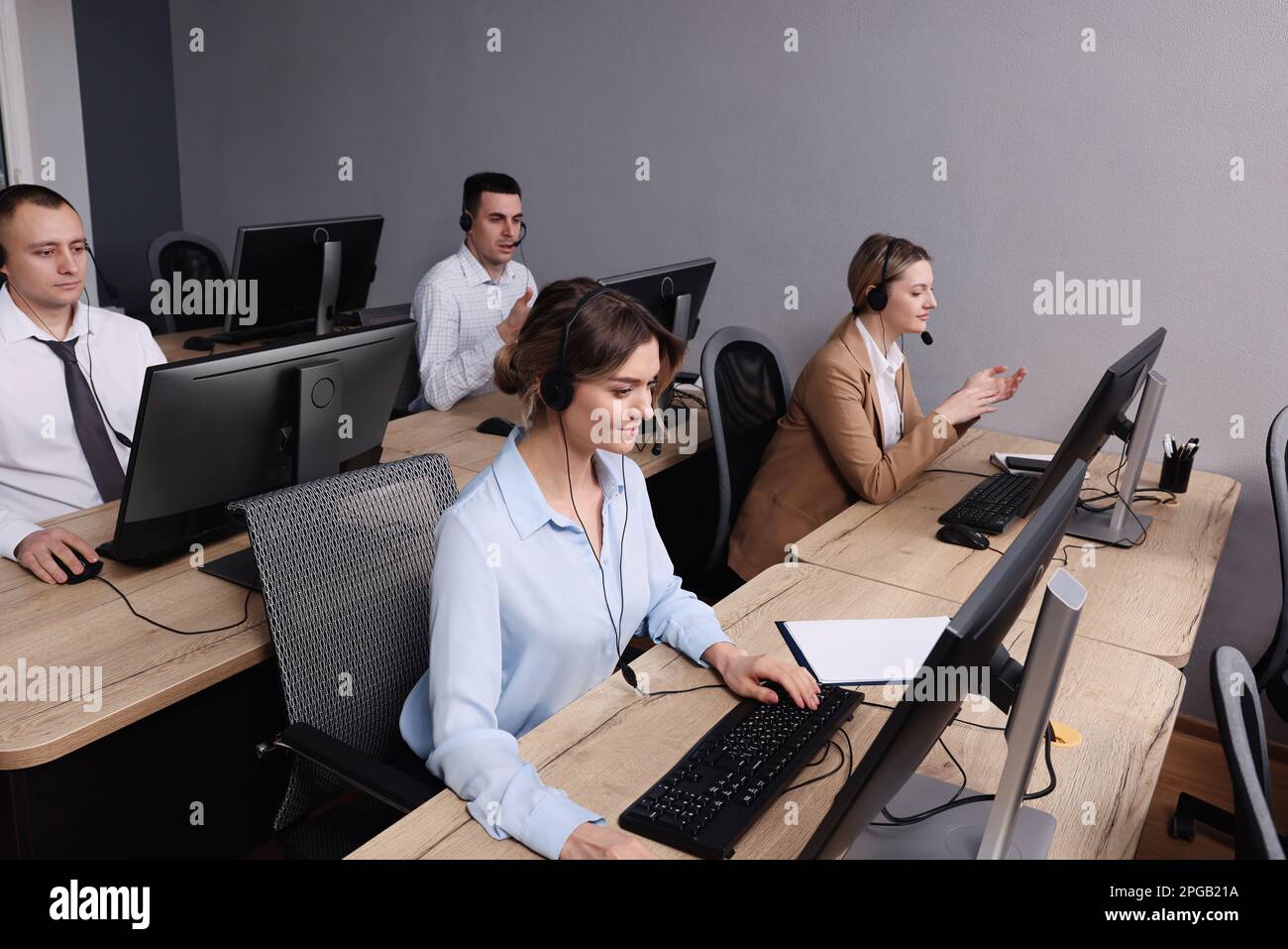 Call center operators working in modern office Stock Photo - Alamy