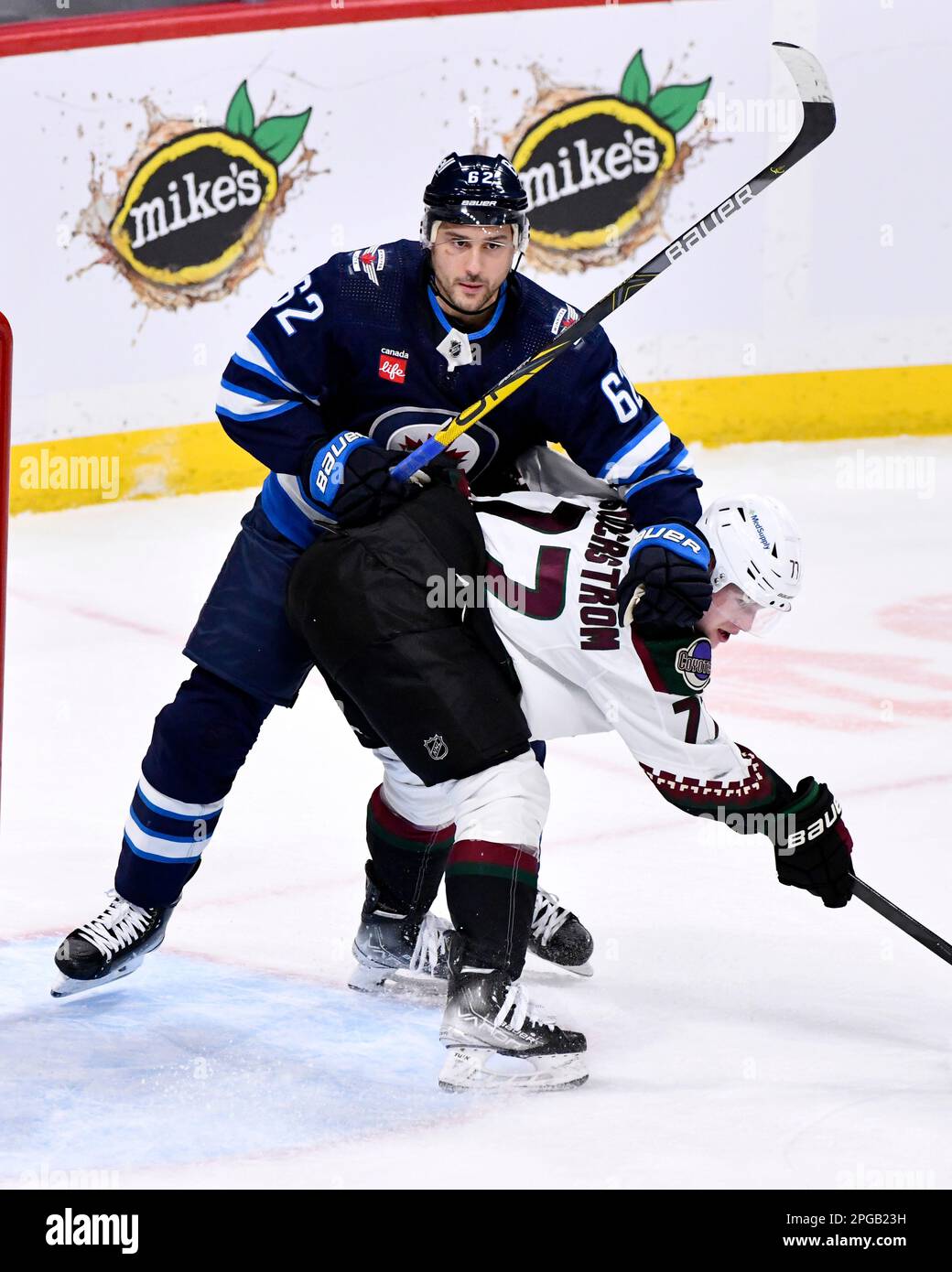 Arizona Coyotes' Victor Soderstrom (77) is checked by Winnipeg Jets ...