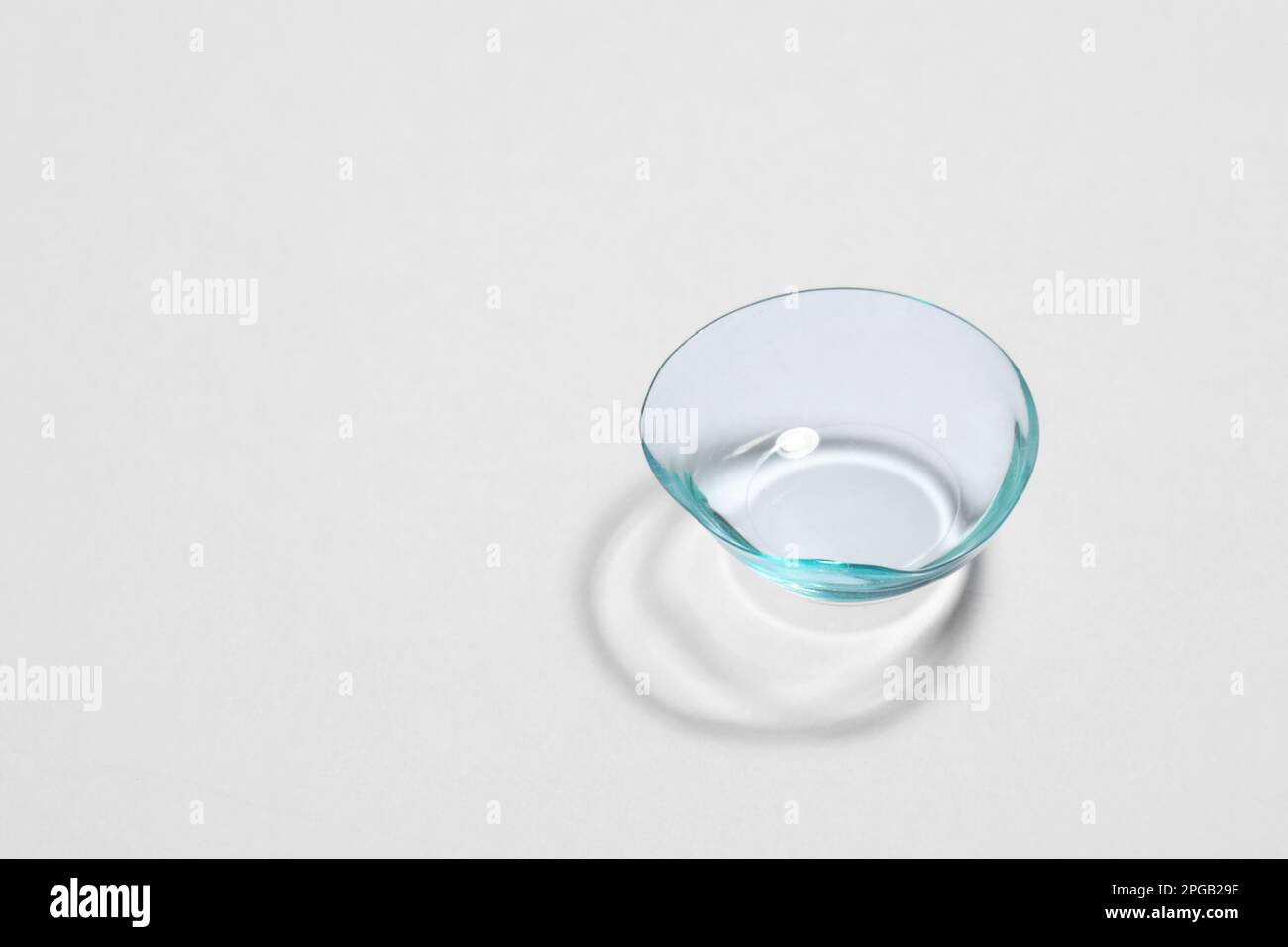 One contact lens on white background, space for text Stock Photo - Alamy