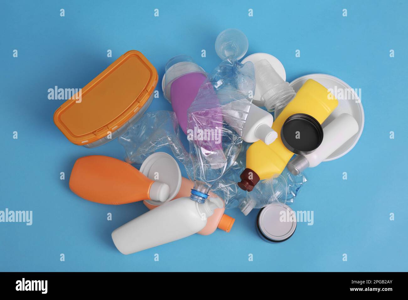 Pile of plastic garbage on light blue background, flat lay Stock Photo ...