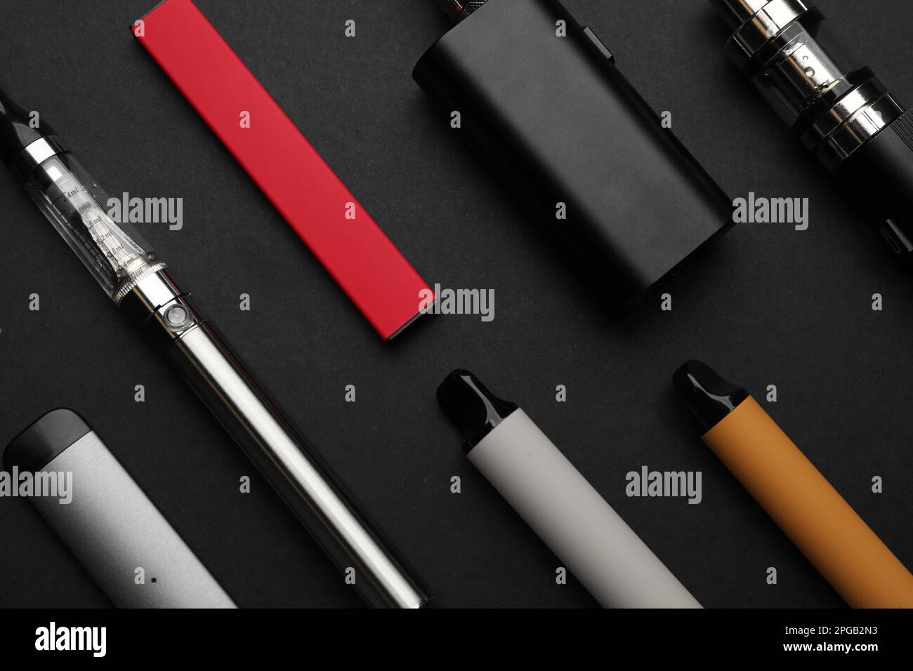 Many electronic smoking devices on black background, flat lay Stock ...