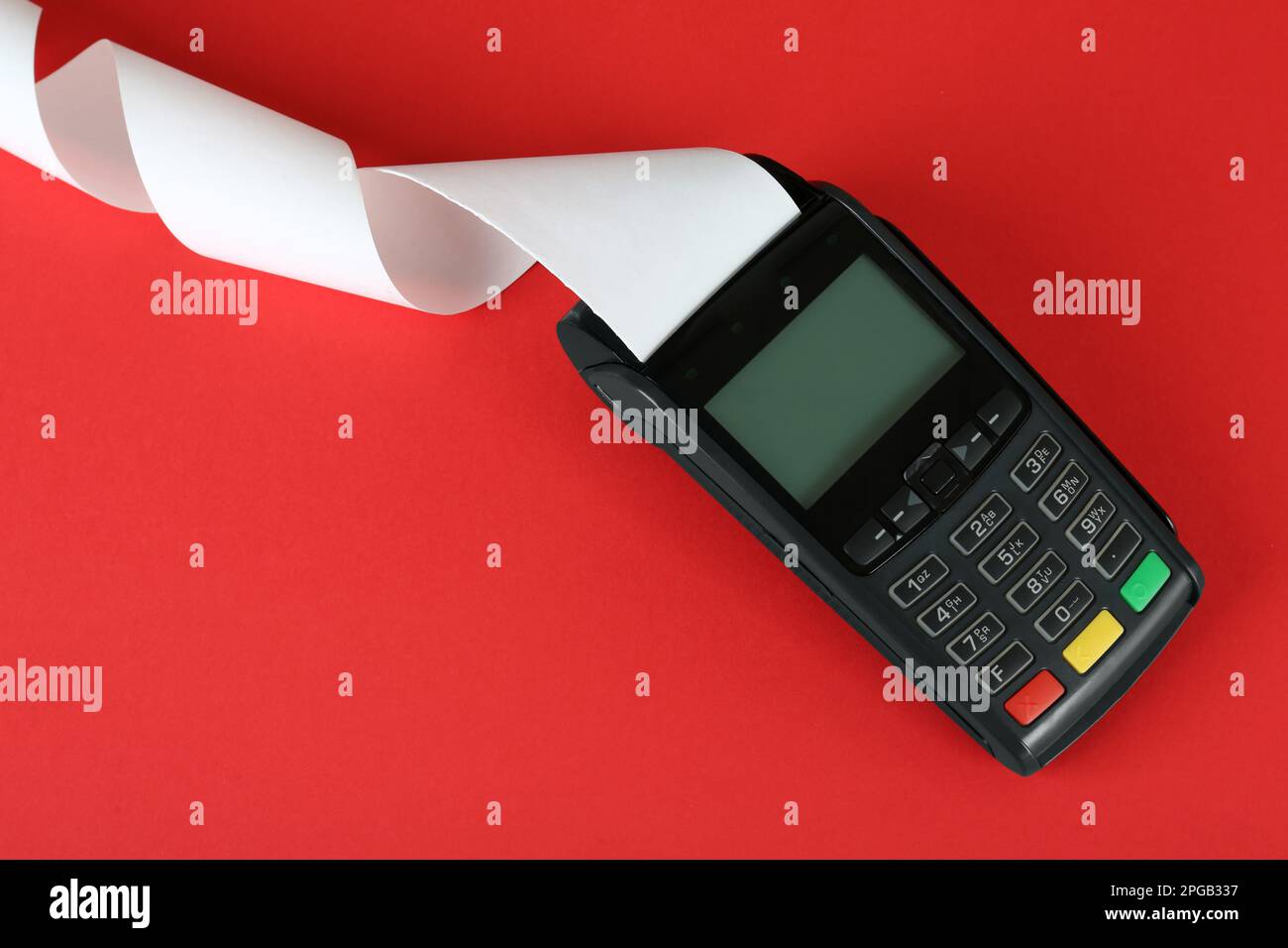 New modern payment terminal with blank paper bill on red background ...