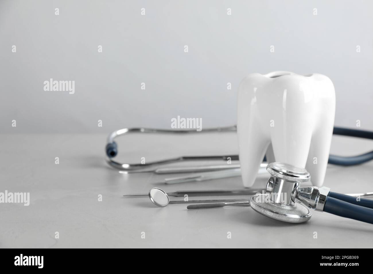 Tooth shaped holder, set of different dentist's tools and stethoscope ...