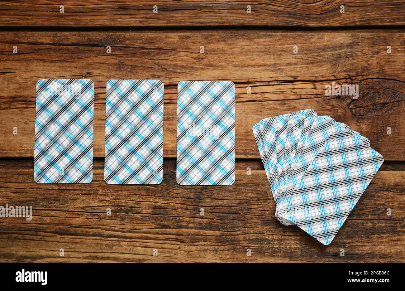 Tarot cards on wooden table, flat lay. Reverse side Stock Photo - Alamy