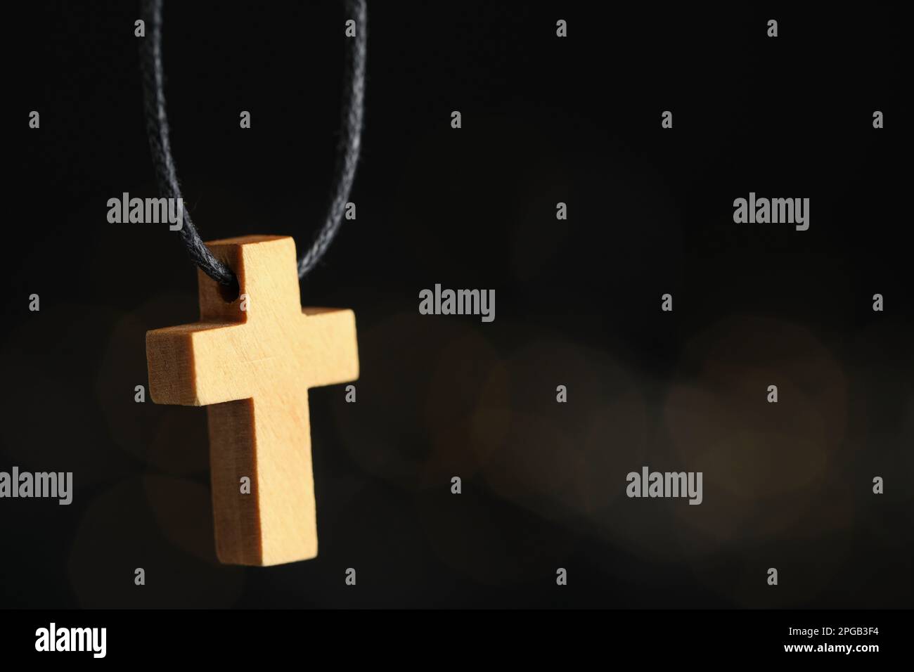 Christian cross on black background, closeup. Space copy text Stock ...