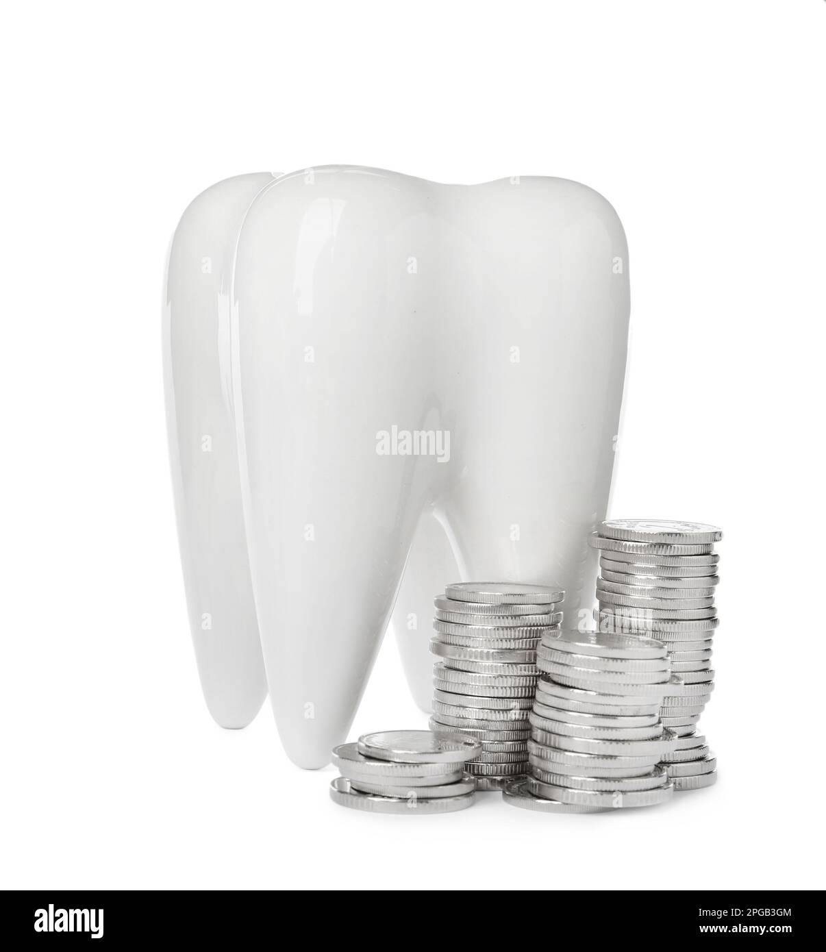 Ceramic model of tooth and coins on white background. Expensive ...