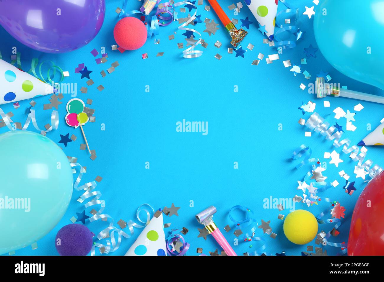 Frame of colorful serpentine streamers and other party accessories on ...