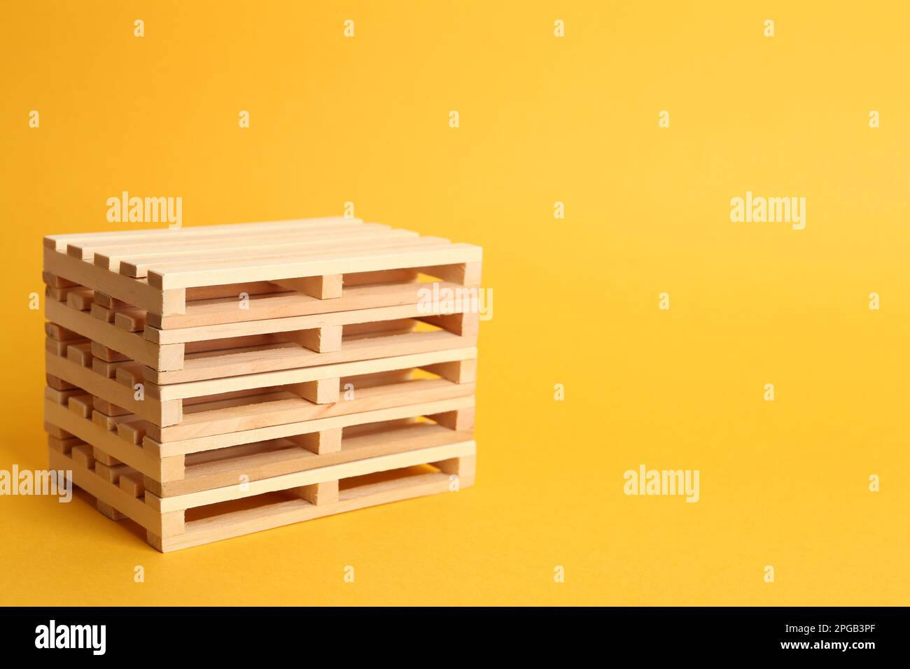 Stack of wooden pallets on orange background, space for text Stock ...