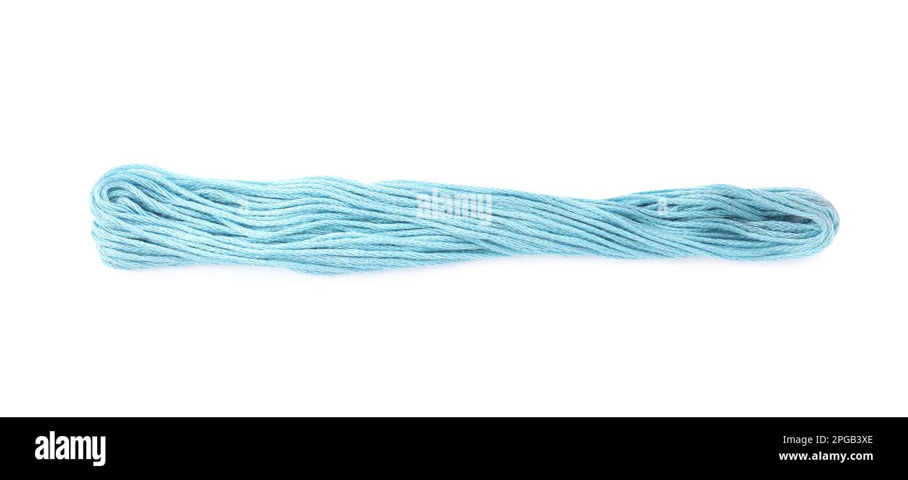 Light blue embroidery thread on white background Stock Photo - Alamy