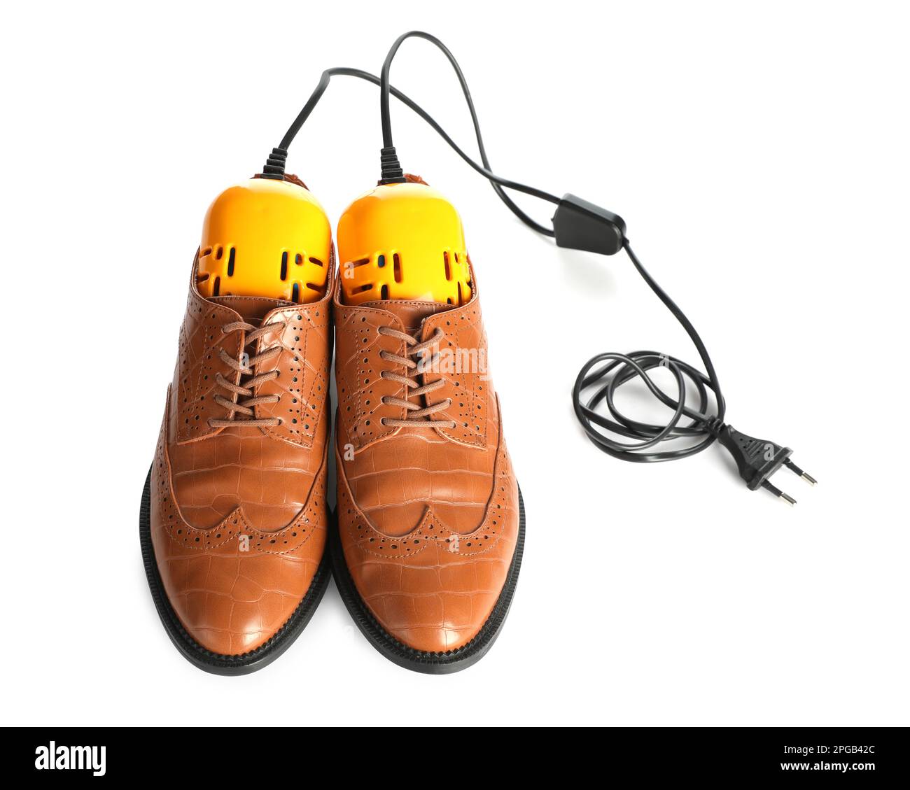 Pair of stylish shoes with modern electric footwear dryer on white ...