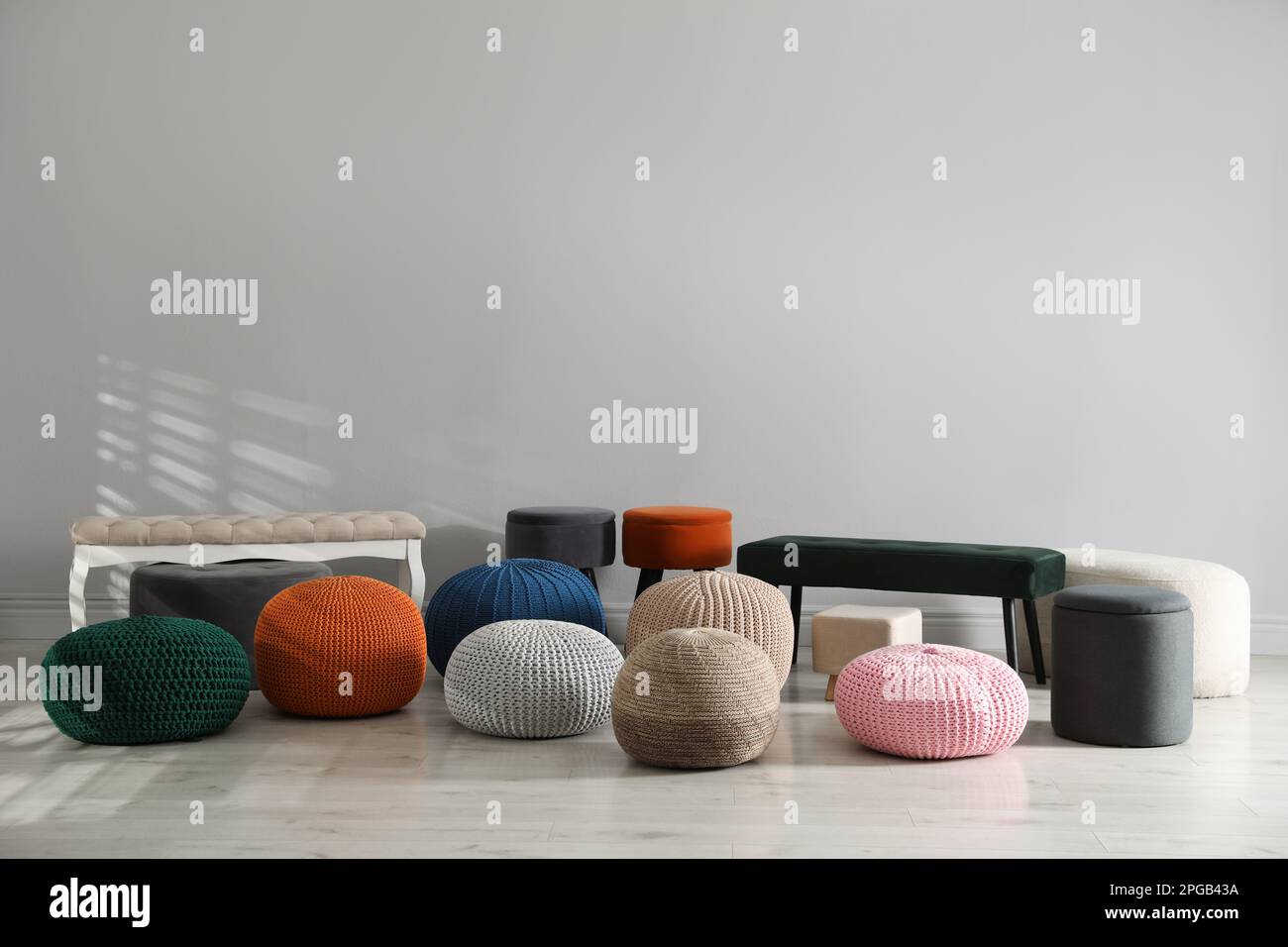 Many stylish different poufs and benches indoors. Home design Stock ...