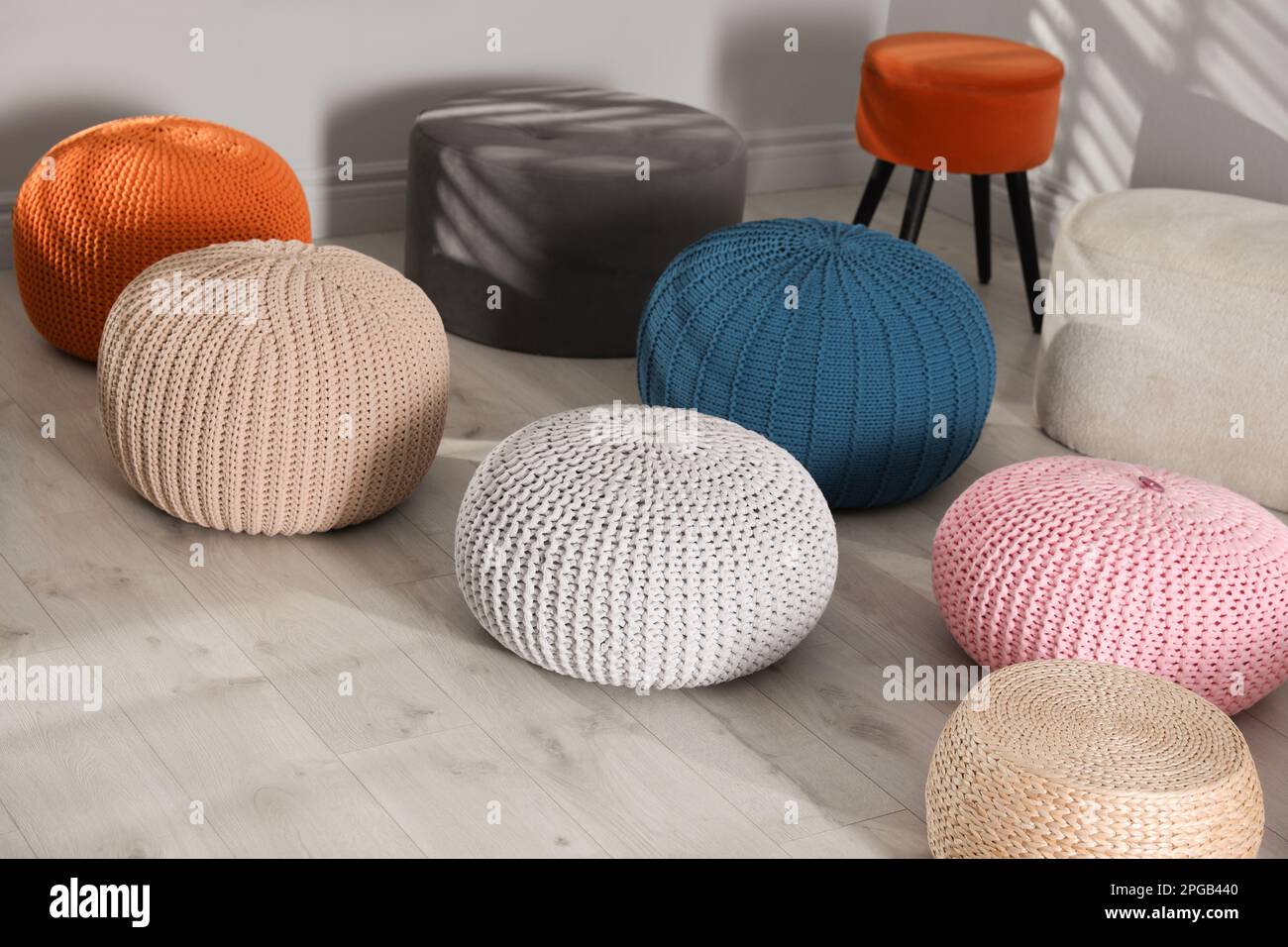 Many stylish different poufs indoors. Home design Stock Photo - Alamy