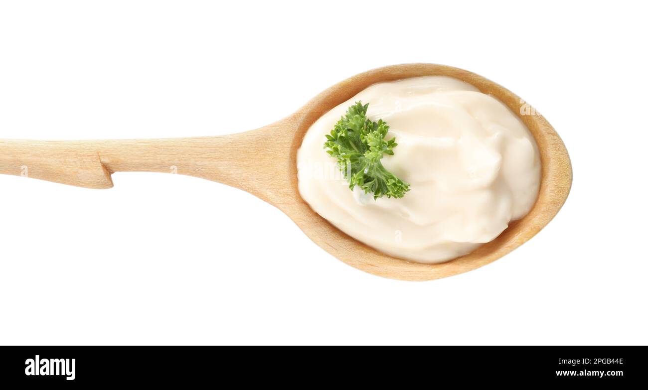 Wooden spoon with tasty mayonnaise and parsley isolated on white, top ...