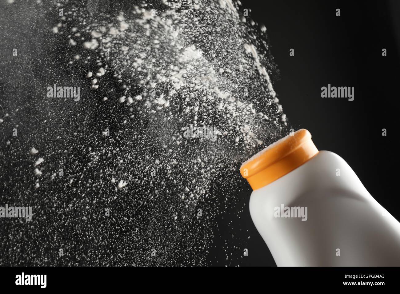 Scattering of dusting powder on black background Stock Photo - Alamy