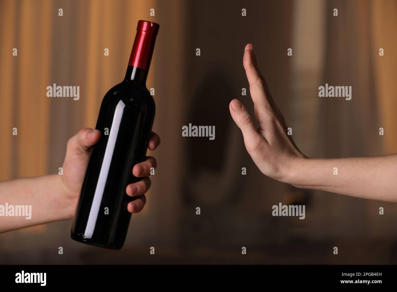 Woman refusing to drink red wine indoors, closeup. Alcohol addiction ...