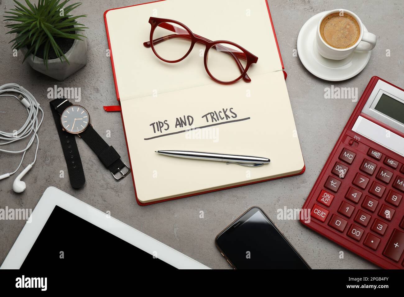 Flat lay composition with notebook on grey table. Tips and Tricks Stock ...