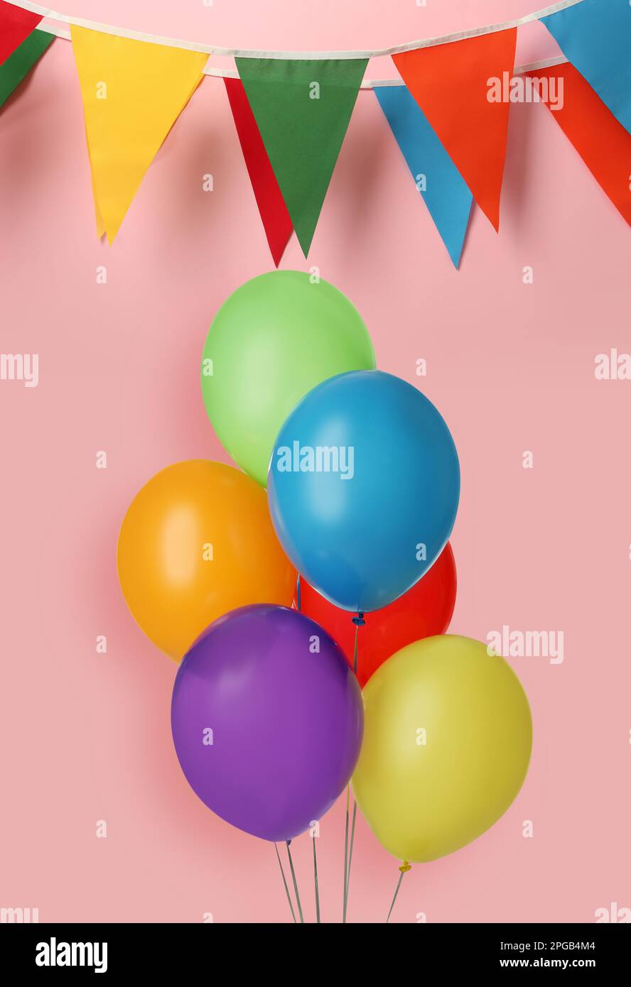 Colorful balloons and decorative bunting flags on pink background Stock ...