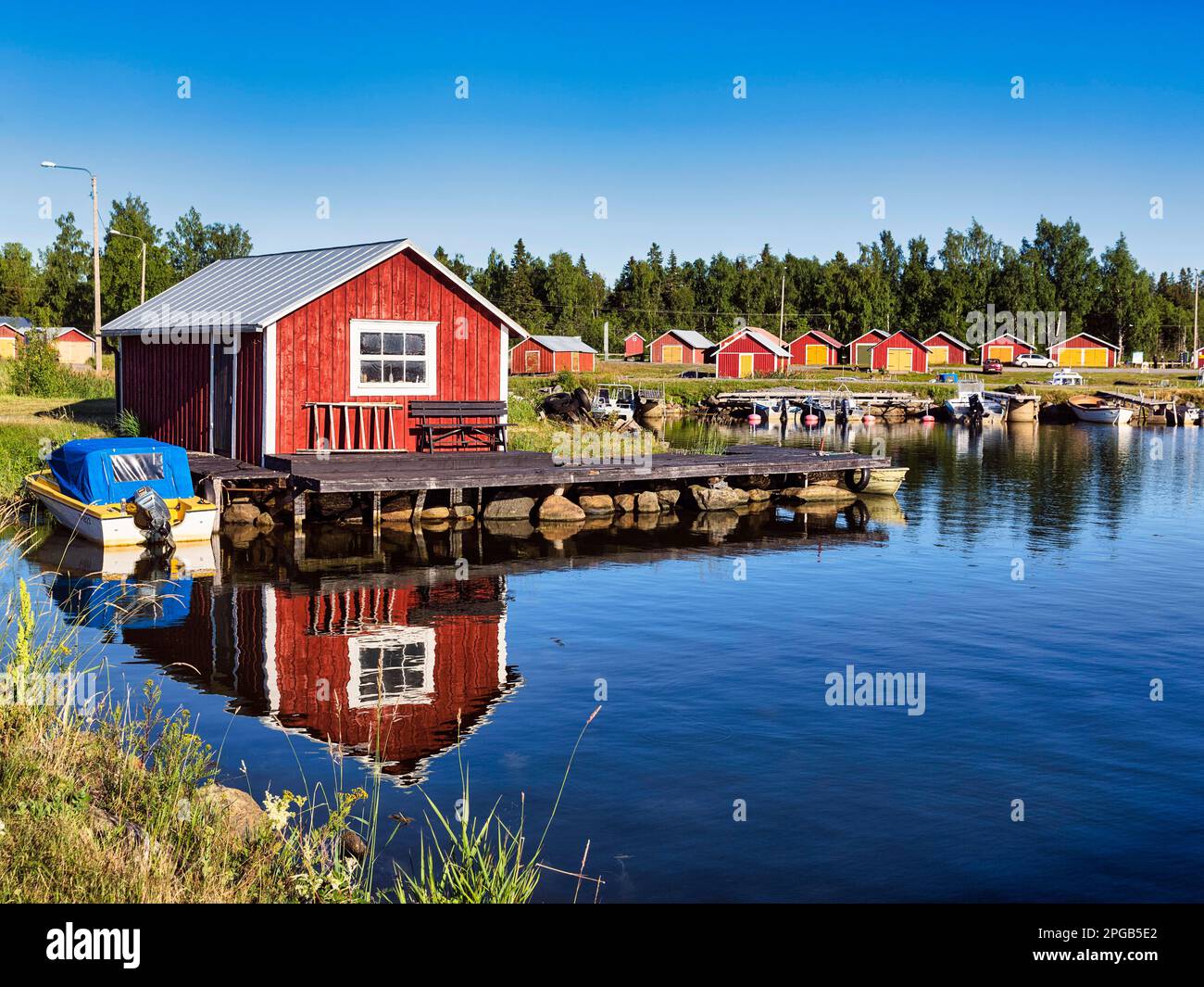 Red boathouses in Svedjehamn fishing harbour, idyll on the Baltic coast ...
