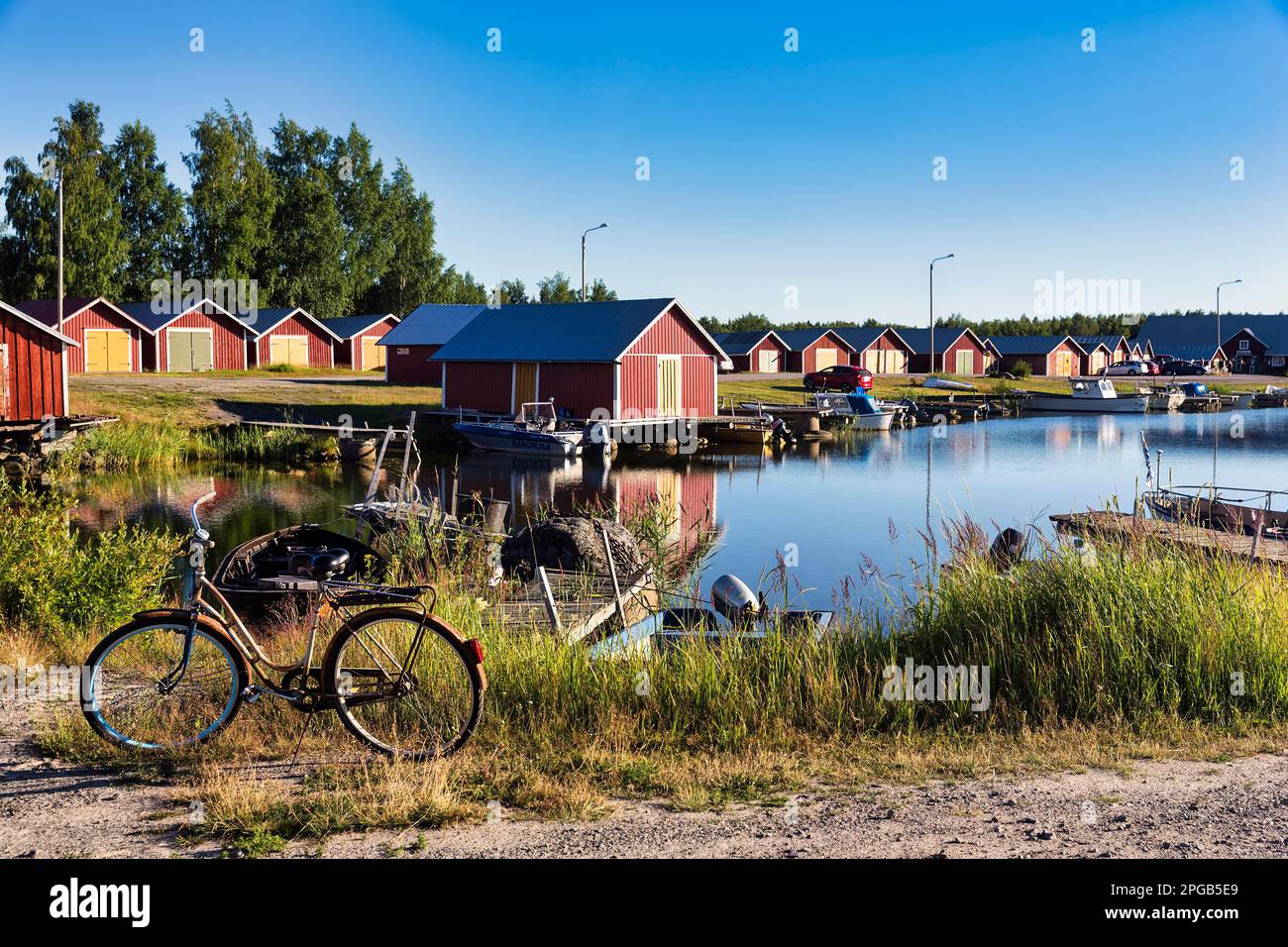 Red boathouses in Svedjehamn fishing harbour, Bjoerkoeby, Korsholm ...