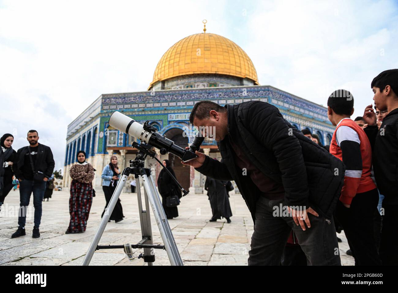 Jerusalem, Israel. 21st Mar, 2023. A man uses a telescope to search for ...