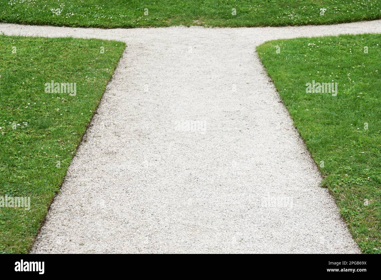 gravel path junction. fork in the road. decision concept with copy ...