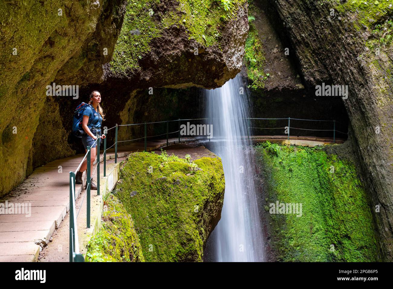 Hiker at Levada do Moinho, Waterfall in a gorge, Ponta do Sol, Madeira ...