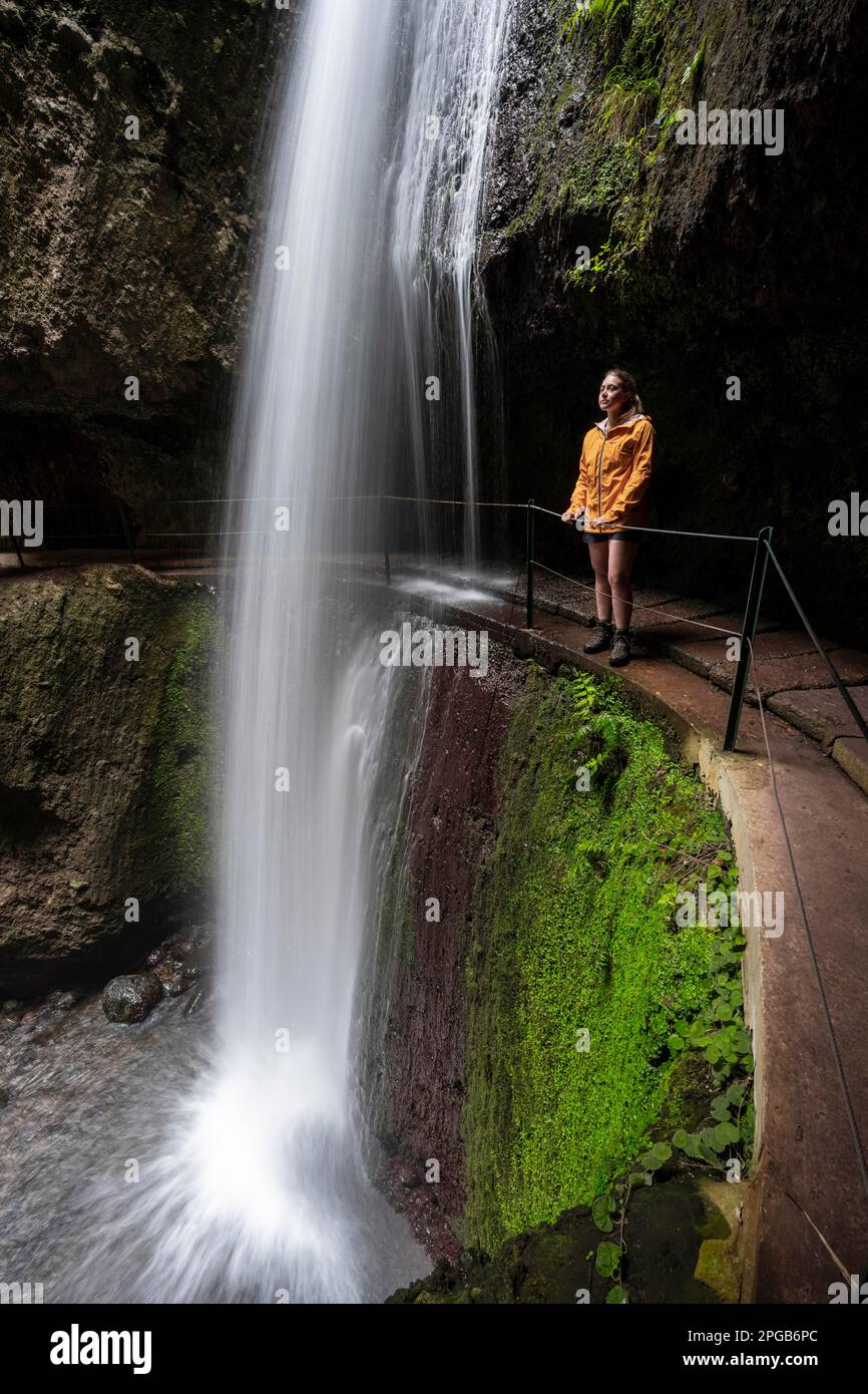 Hiker at Levada do Moinho, Waterfall in a gorge, Ponta do Sol, Madeira ...