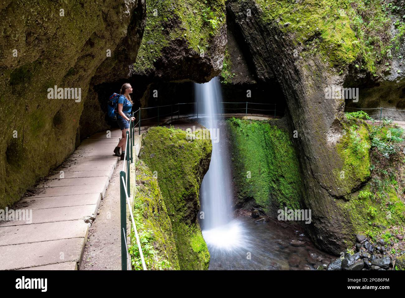 Hiker at Levada do Moinho, Waterfall in a gorge, Ponta do Sol, Madeira ...