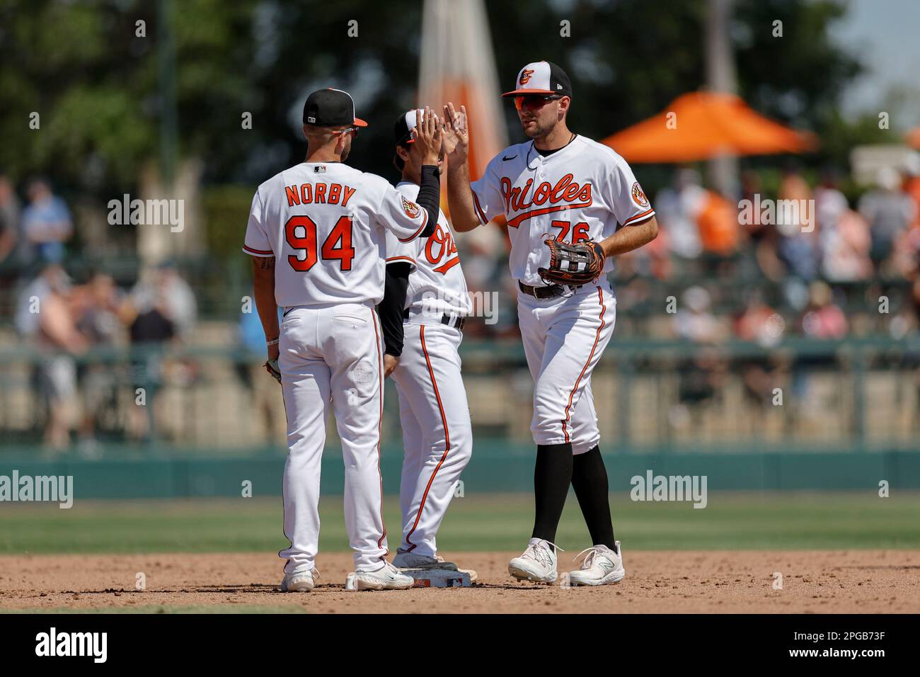 Sarasota FL USA; Baltimore Orioles second baseman Connor Norby (94) high fivers outfielders ...