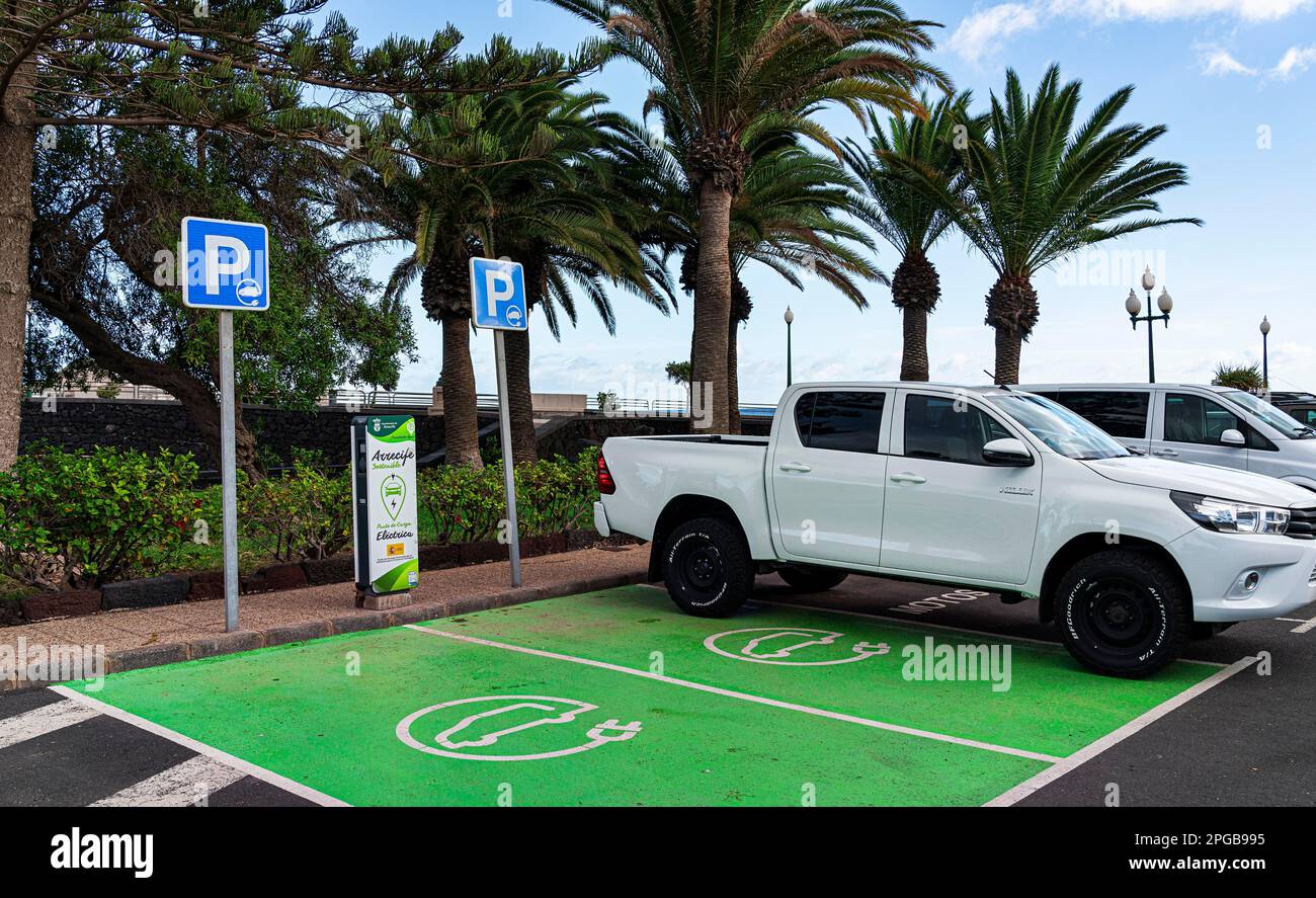 Green parking area with Iberdrola charging station for electric car ...