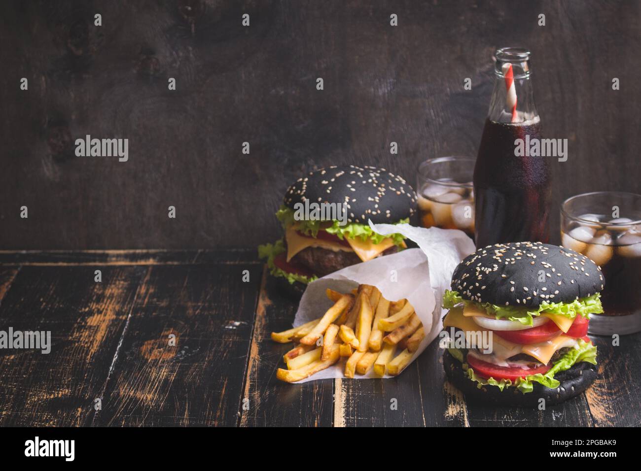 Set of black burgers with meat patty, cheese, tomatoes, mayonnaise ...