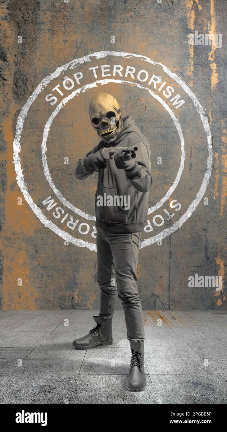 A man wearing a mask holding a gun with stop terrorism sign on a wall ...