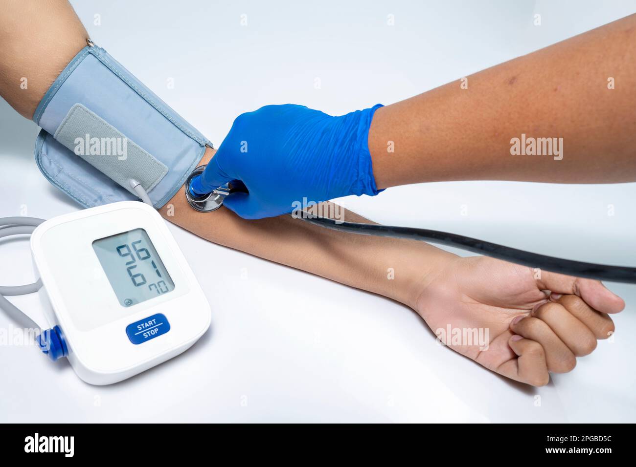 Doctor checking patient blood pressure with digital monitor Stock Photo ...