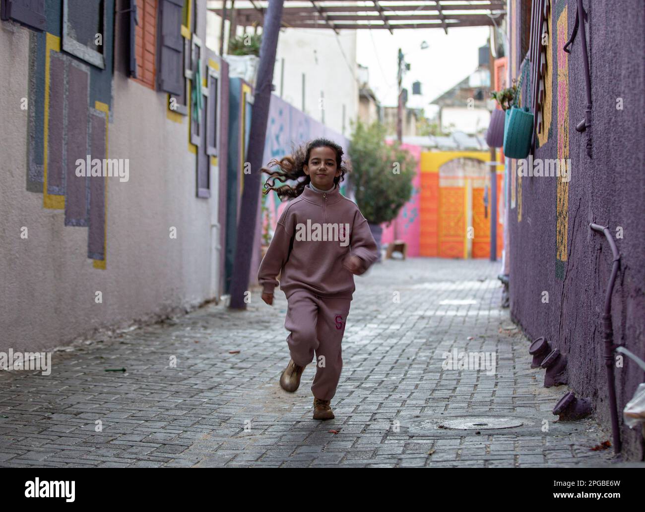 Gaza, Palestine. 21st Mar, 2023. A Palestinian girl runs in an area ...