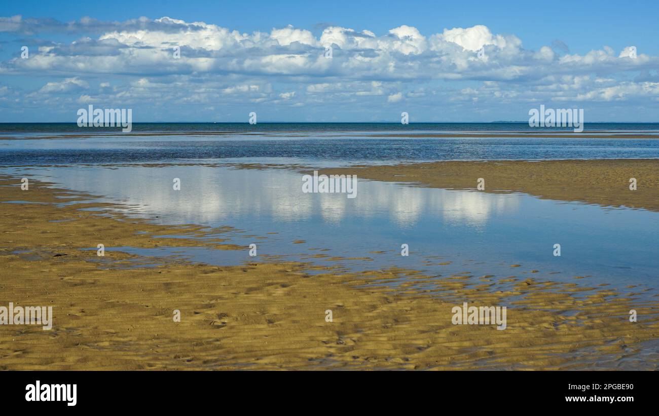 Beautiful tranquil scene with white clouds reflected in the calm ...