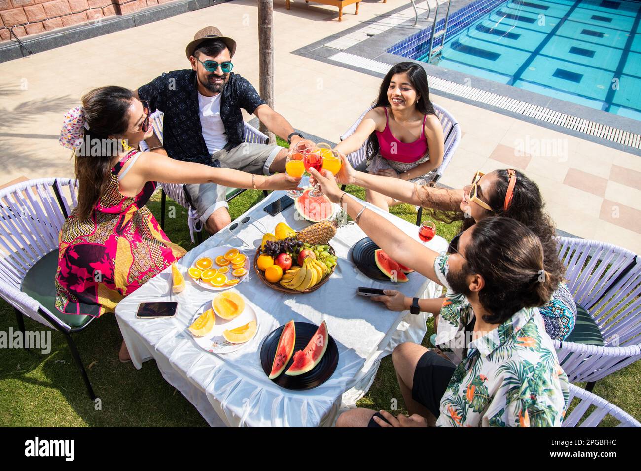 Group Of Indian Friends Toasting Cocktail At Outdoors Summer Party
