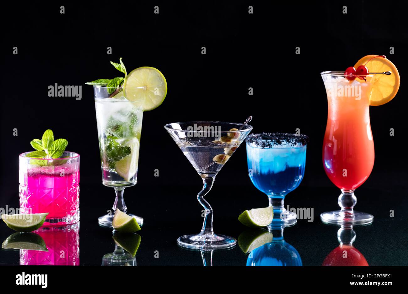 Bright colourful cocktails in a row, against a black background Stock ...