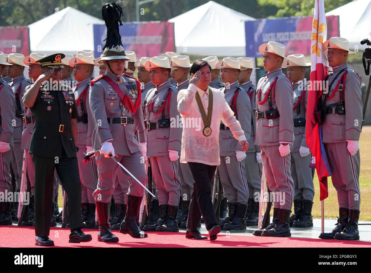 Philippine President Ferdinand Marcos Jr., right, salutes beside ...