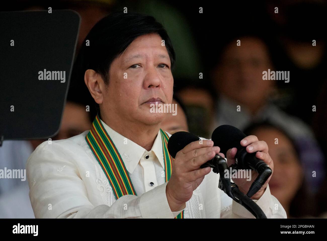 Philippine President Ferdinand Marcos Jr. arranges the mic before ...