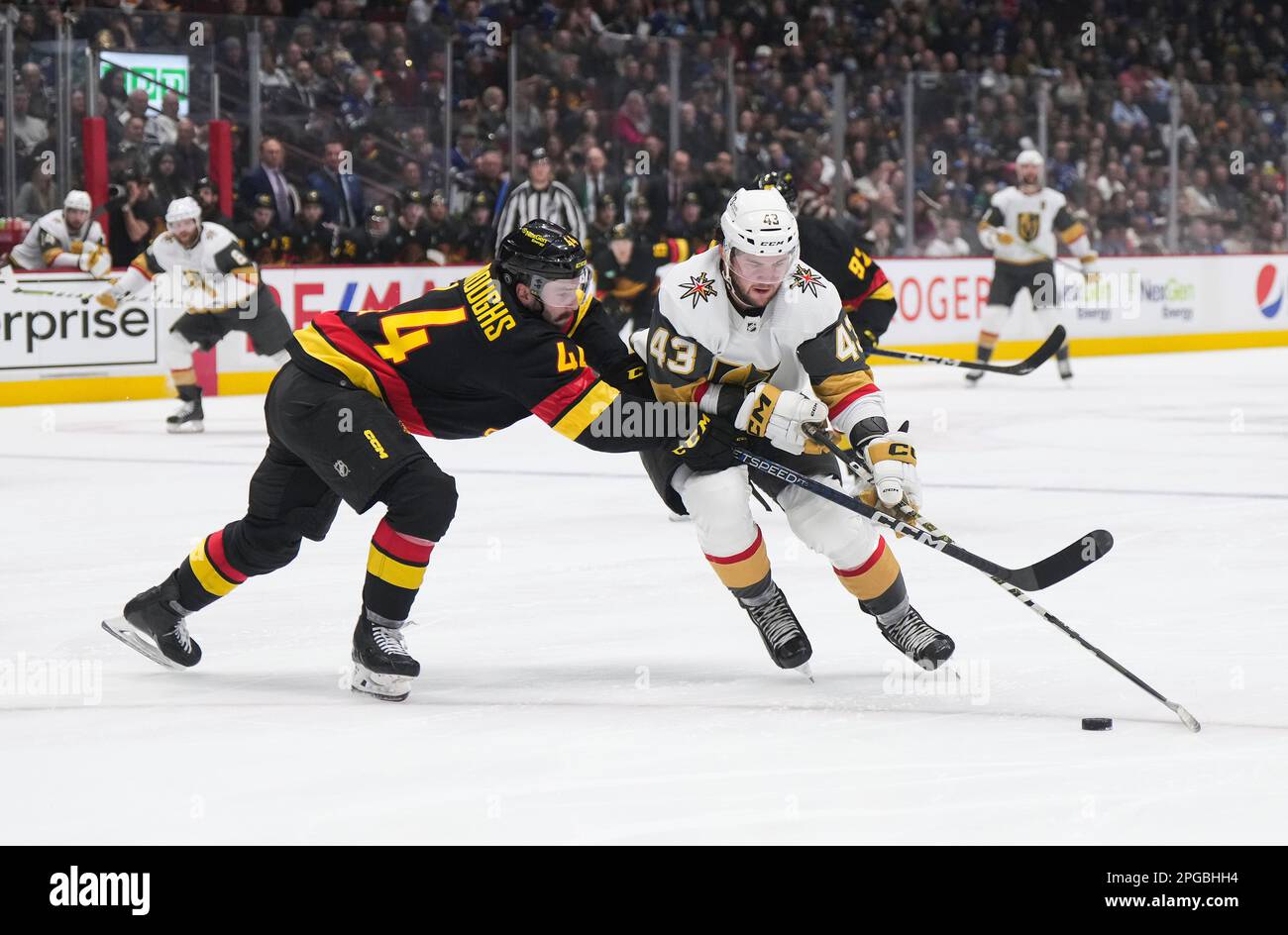 Vancouver Canucks' Kyle Burroughs, left, checks Vegas Golden Knights ...
