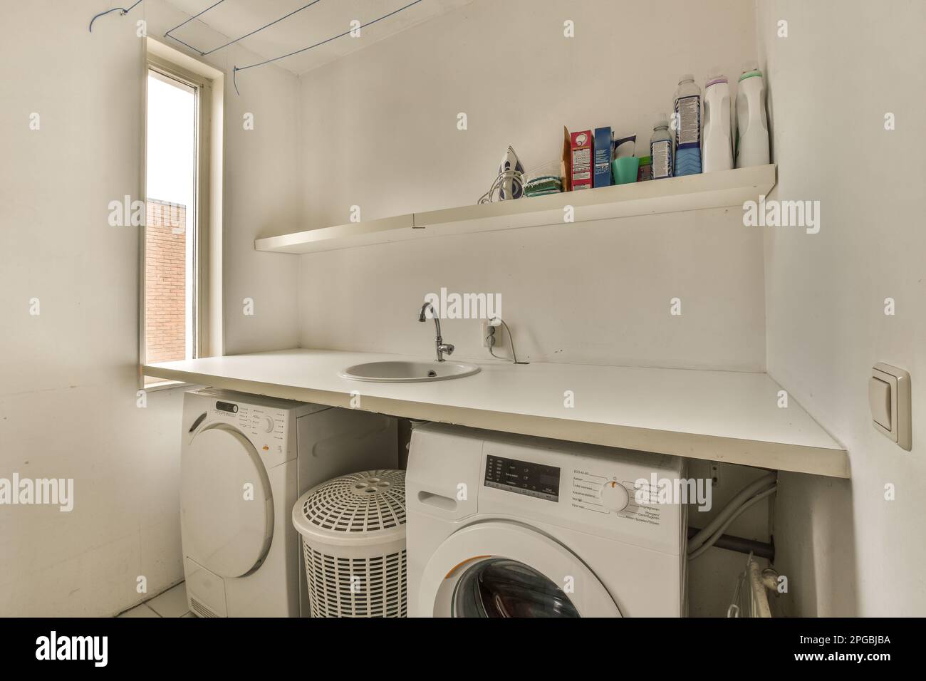 a laundry room with a washer and dryer next to the washing machine on ...