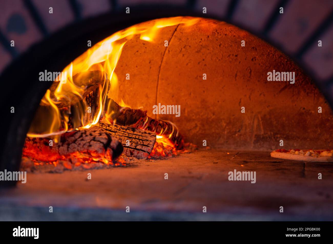 A pizza being cooked in a italian brick oven Stock Photo - Alamy