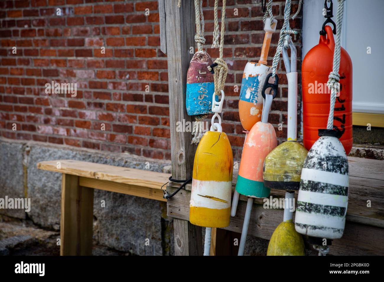 Vintage Buoys in front of a shed in New England Stock Photo - Alamy