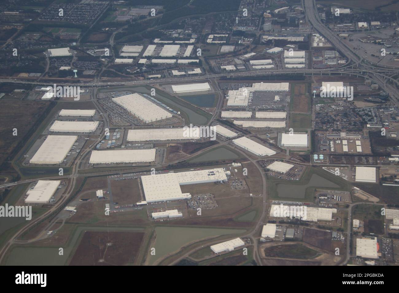 From above, the sprawling industrial warehouse complex stretches as far ...