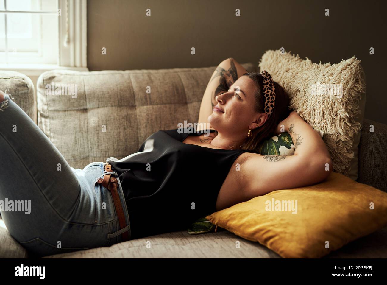 Quality time with her mind. a young woman relaxing on the sofa at home ...