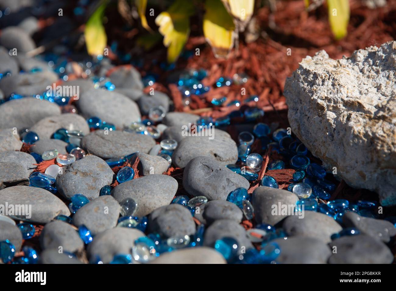 Garden Walkway with Blue rocks represting a stream Stock Photo - Alamy