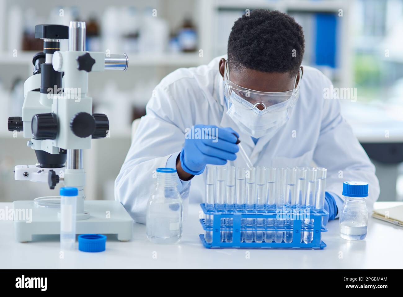 This one should go here. an unrecognizable male scientist pouring a ...
