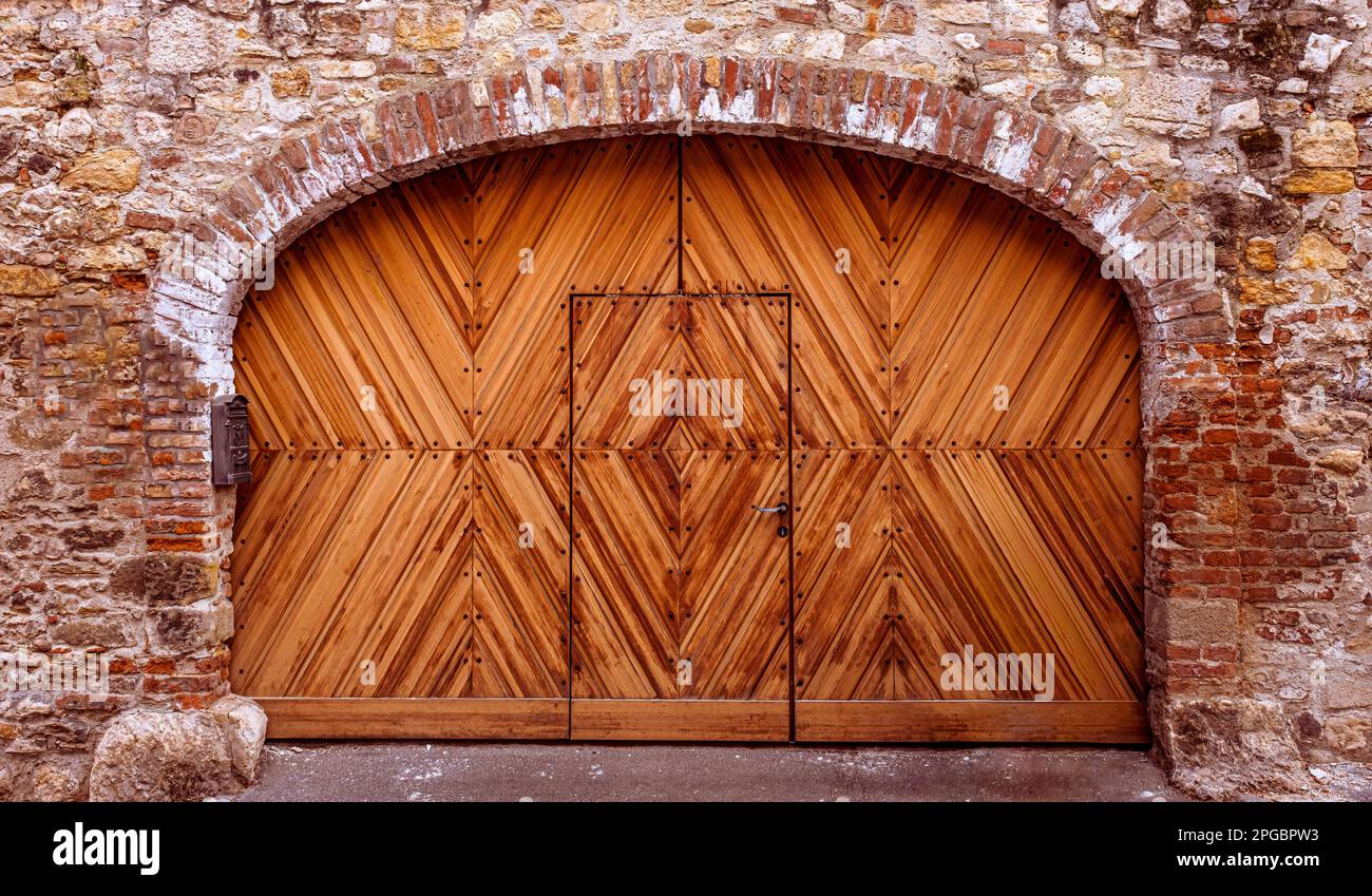 wooden gate with an old red brick wall Stock Photo - Alamy