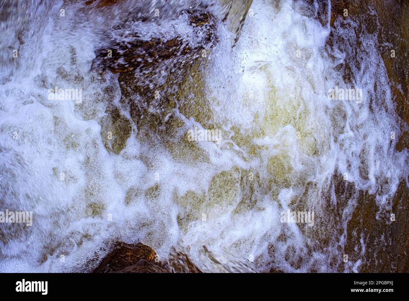 A mountain river flows between rocks in a cascade, Cindrel mountains ...