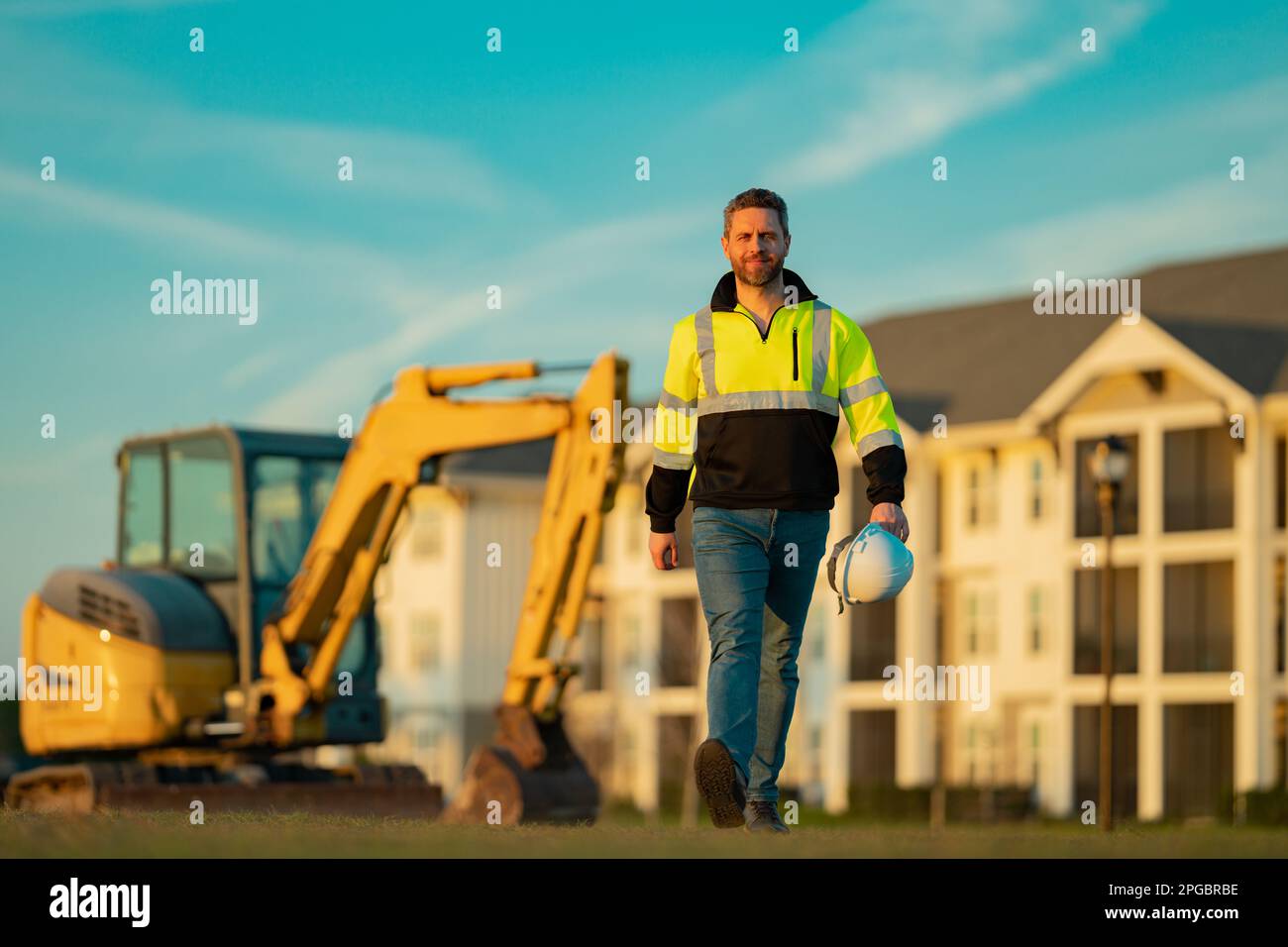 Builder with excavator for construction at the construction site ...